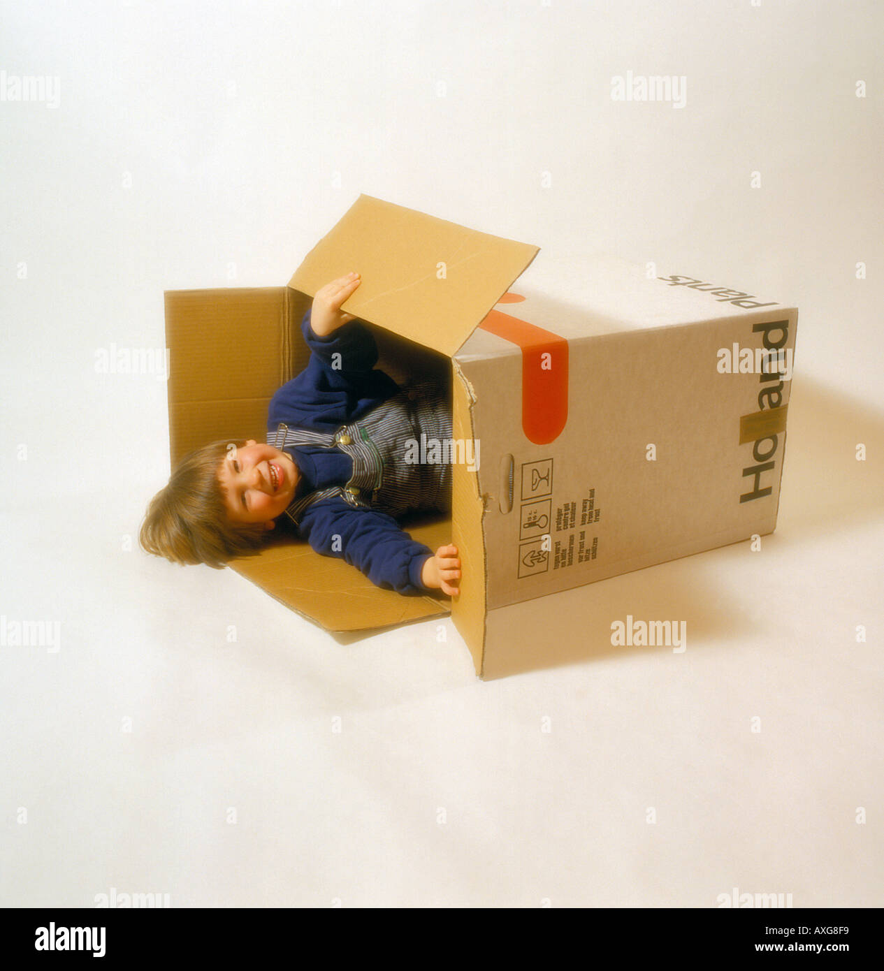 child playing and hiding in a cardboard box. Photo by Willy Matheisl ...