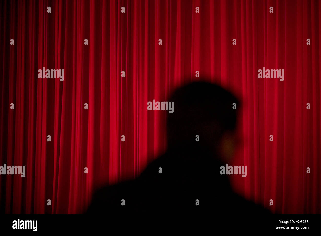 Closed red curtain hanging in a theater Stock Photo - Alamy