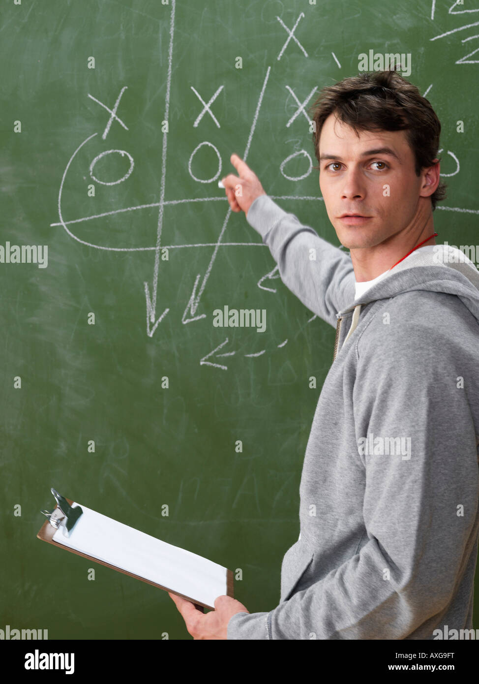 Coach Writing on Blackboard Stock Photo - Alamy