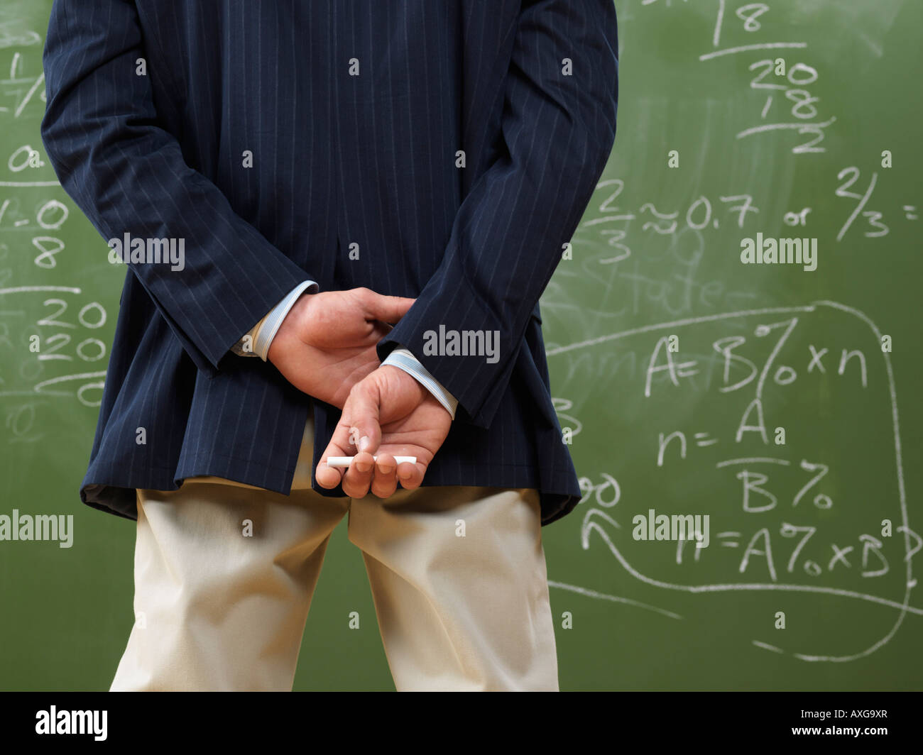 Teacher Looking at Math Problems on Blackboard Stock Photo - Alamy