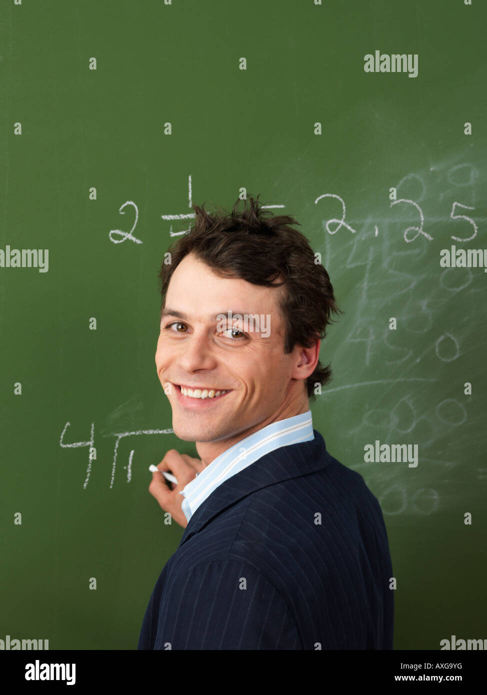 Teacher Writing on Blackboard Stock Photo - Alamy