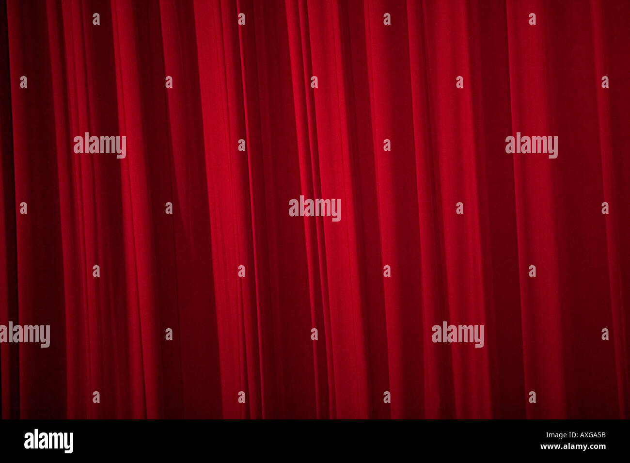 Closed red curtain hanging in a theater Stock Photo - Alamy