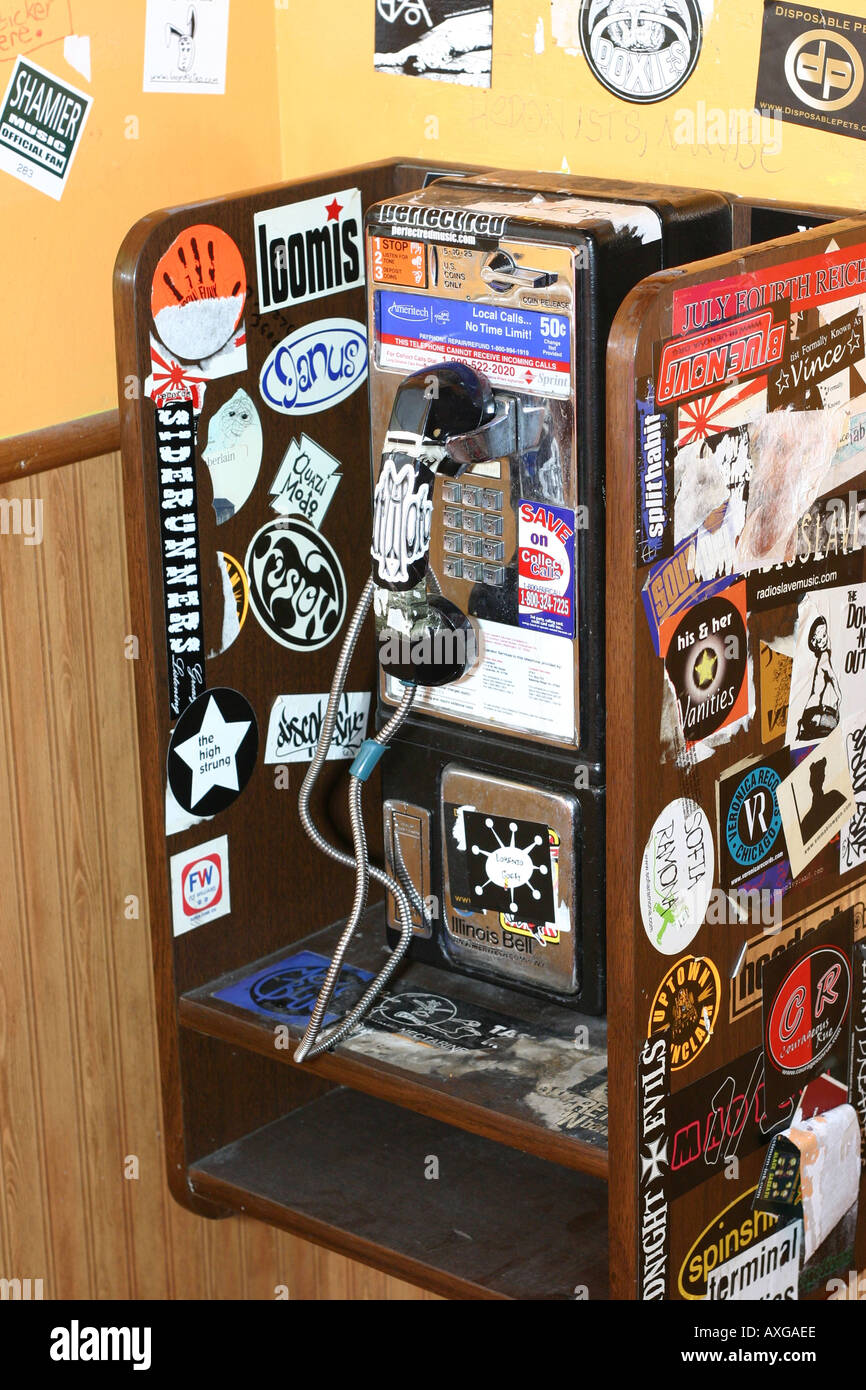 Public phone covered with stickers Stock Photo - Alamy