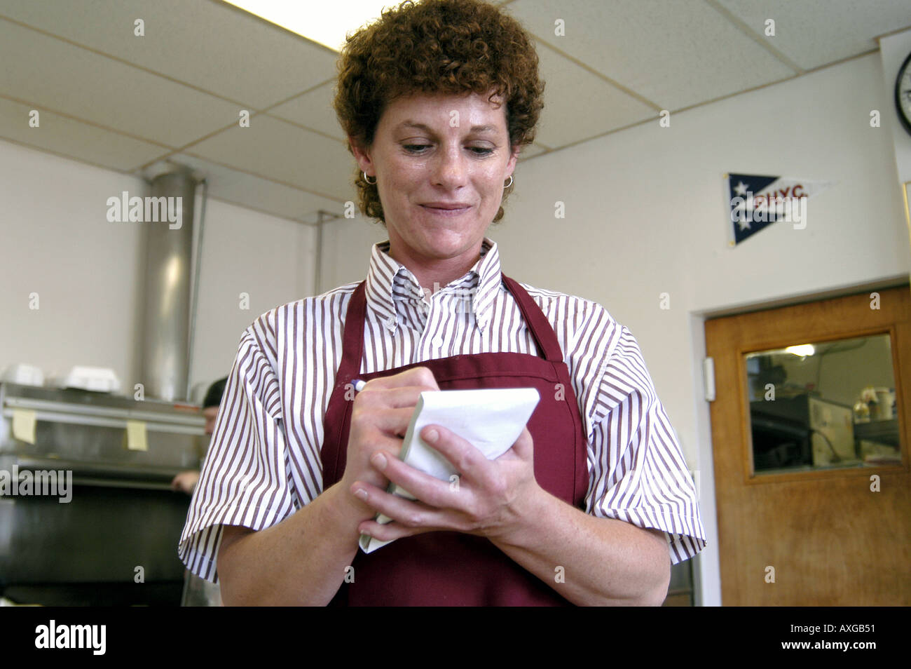 Female waitress takes order for food from customer in a restaurant ...