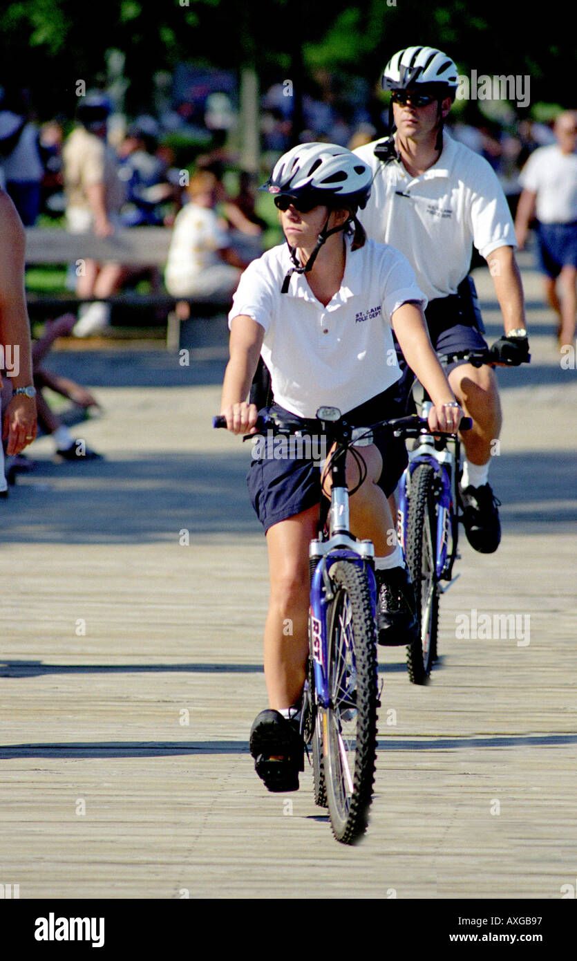 Male and female police officers on bicycle patrol St Clair Michigan ...