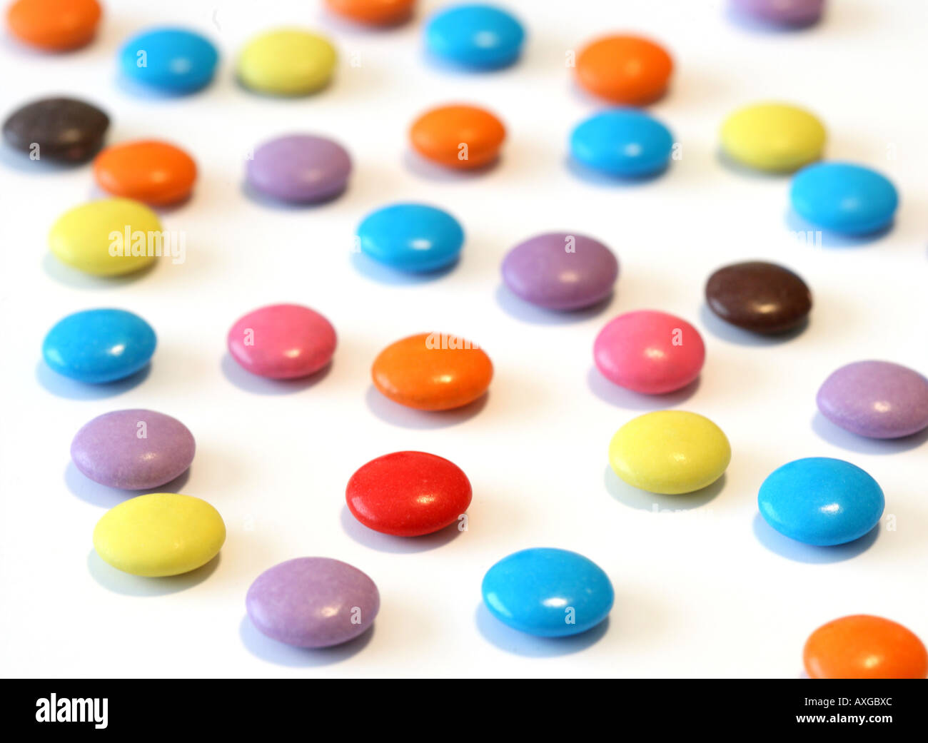 Multi coloured smarties against a white background Stock Photo - Alamy