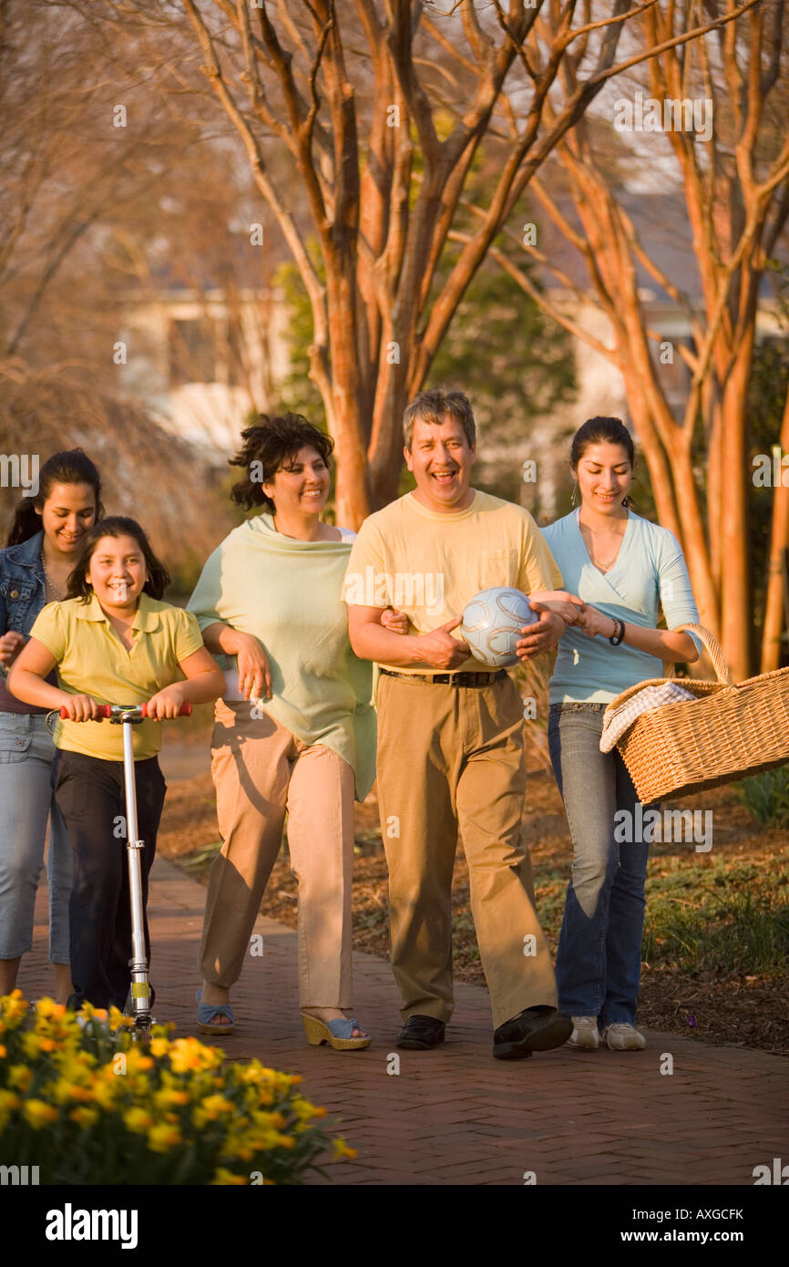 Hispanic family walking in park Stock Photo - Alamy