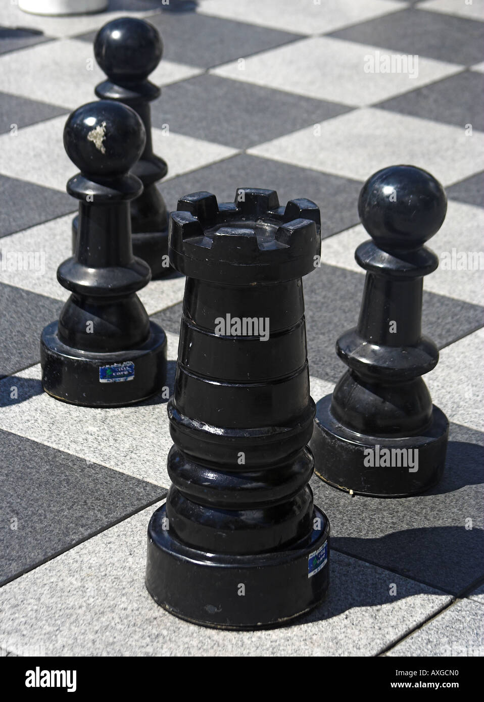Giant black chess pawns on a city centre outdoors chessboard Stock ...