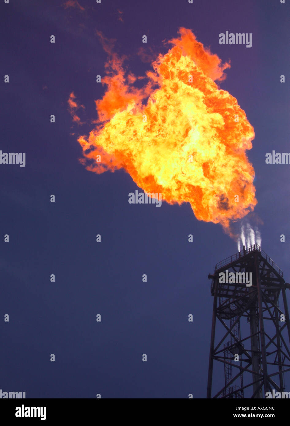 Full frame view of a lit offshore gas flare and column Stock Photo - Alamy