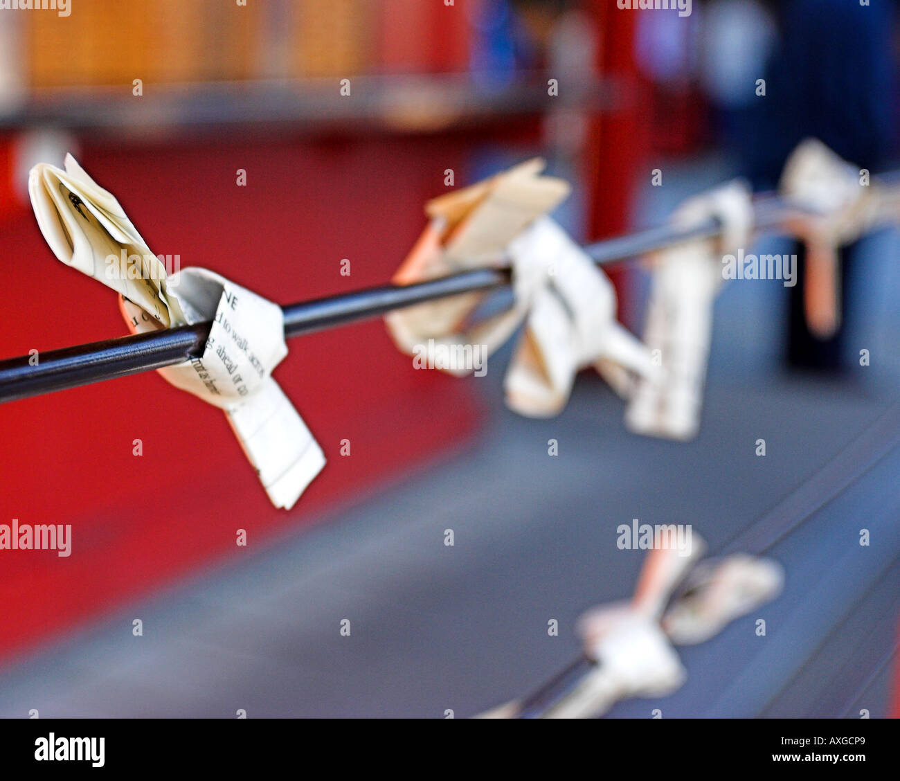 Japanese fortune papers attached to a wire in a Tokyo temple Stock ...