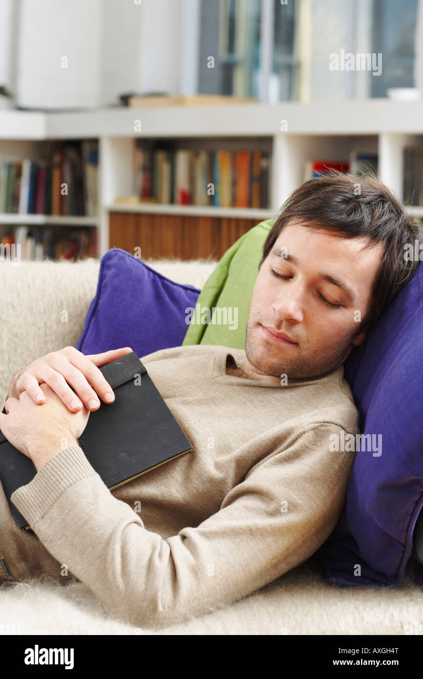 Man asleep on settee hi-res stock photography and images - Alamy