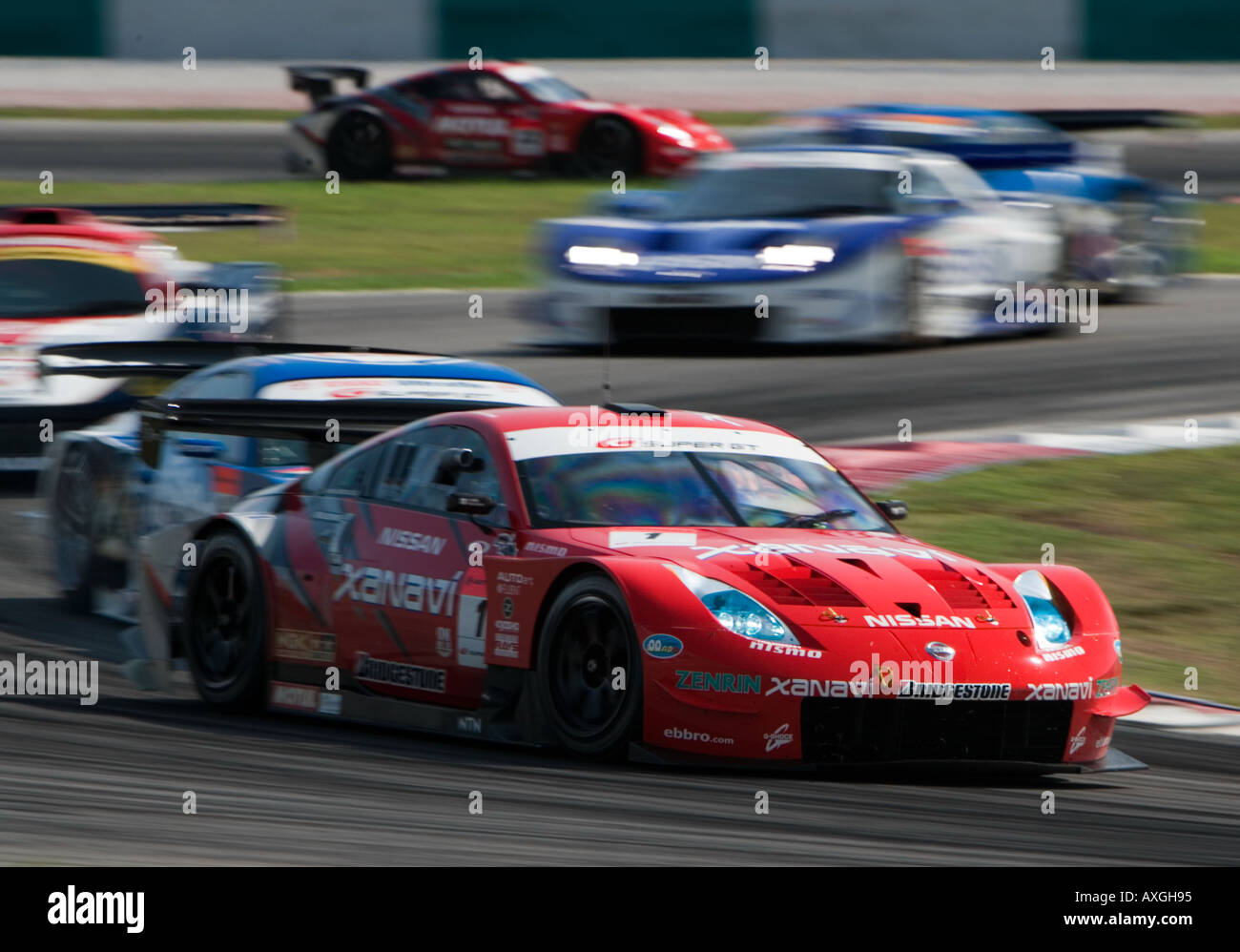 Racing cars led by a red Nissan Fairlady 350Z cornering at the Sepang ...
