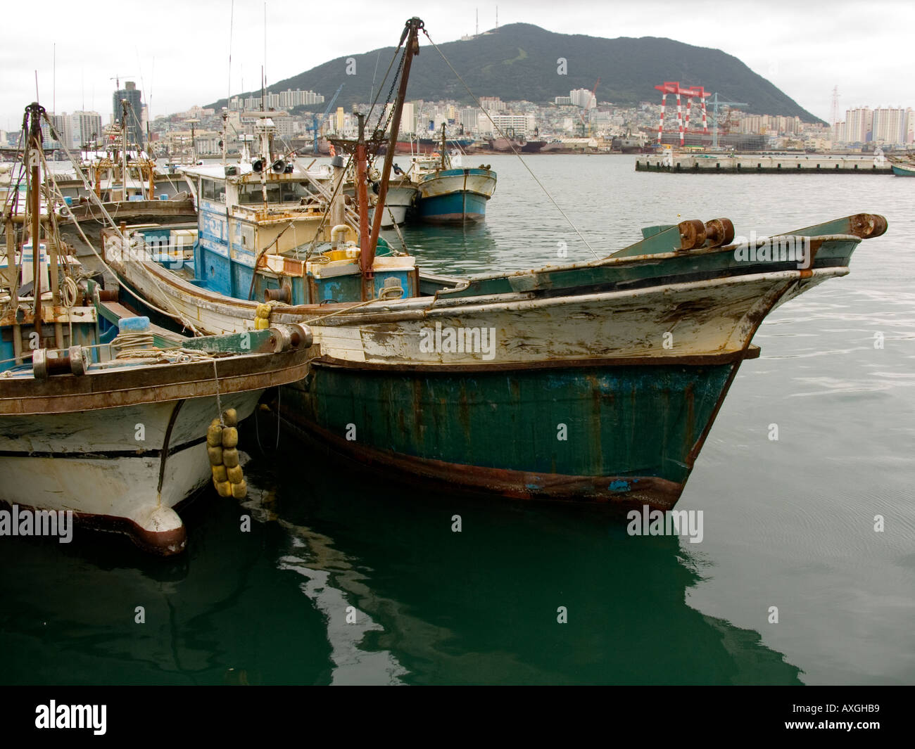 Wooden fishing boats inside harbour Stock Photo - Alamy