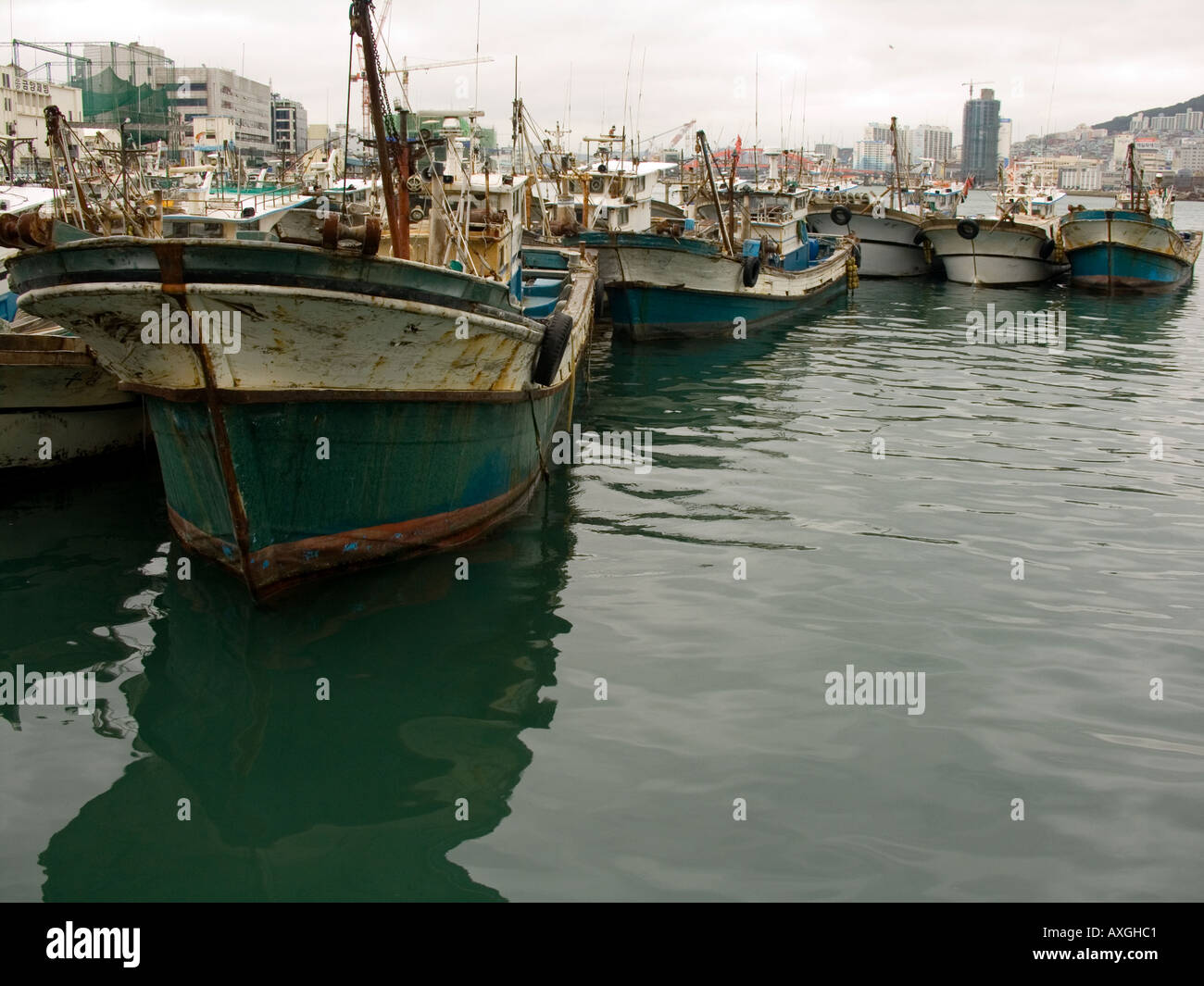 Wooden fishing boats inside harbour Stock Photo - Alamy