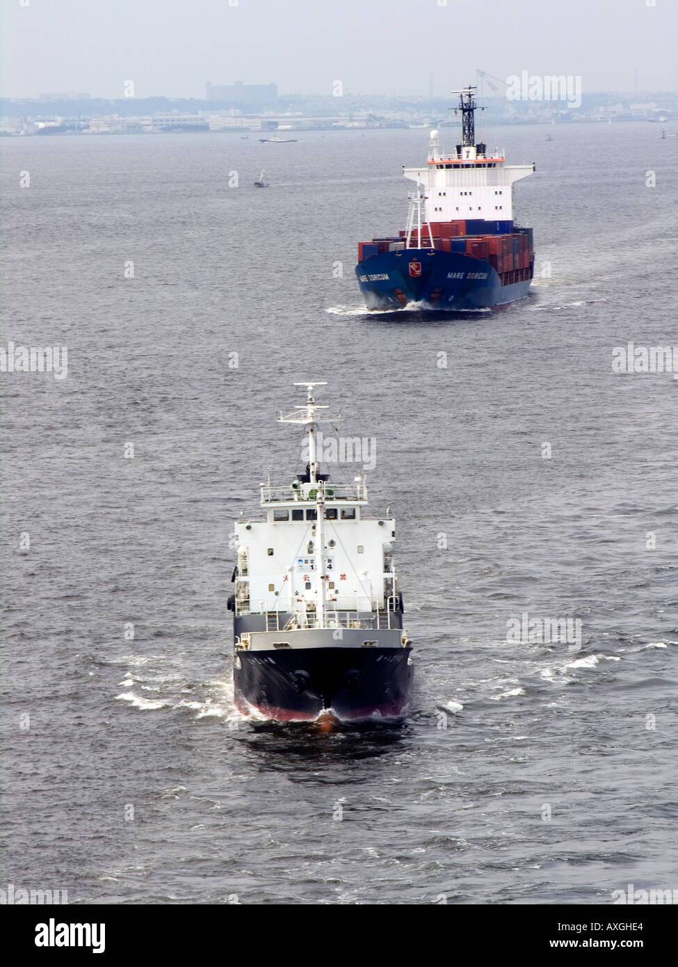Two merchant ships following one another in channel Stock Photo - Alamy
