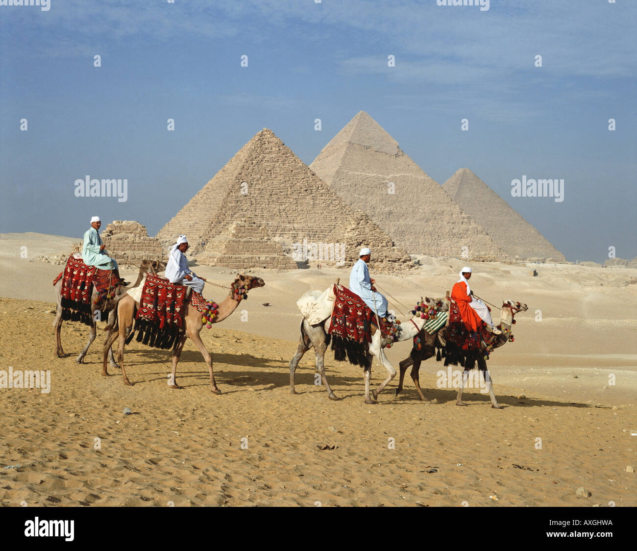 Camel riders at the Giza Pyramids, Cairo, Egypt, North Africa Stock ...