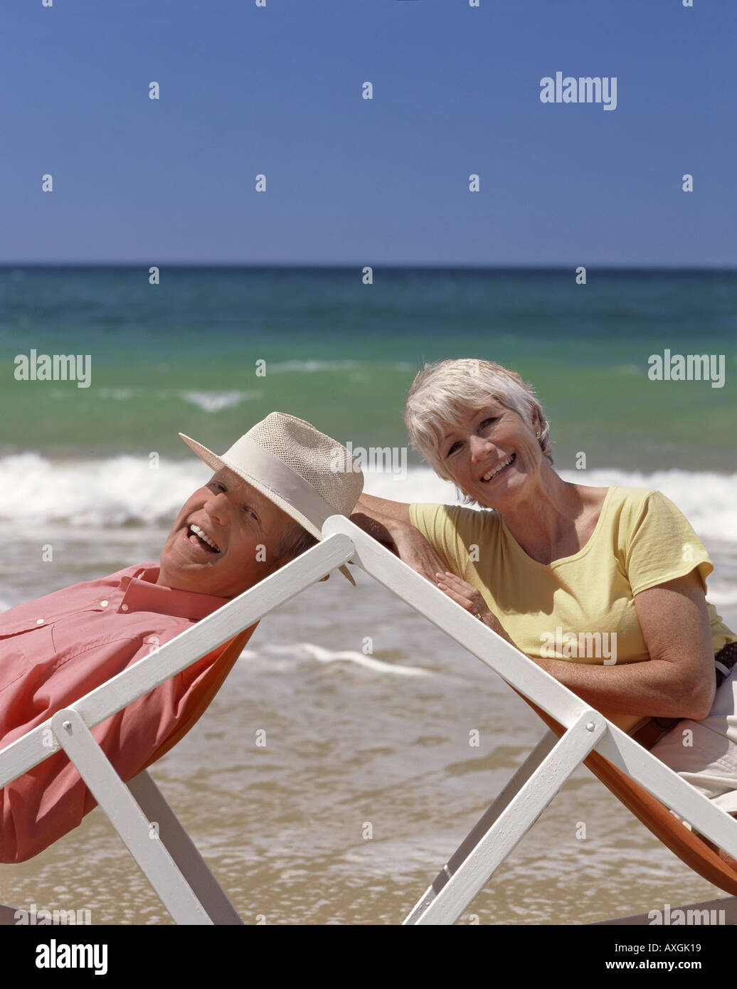 Mature couple sunbathing on beach hi-res stock photography and images ...