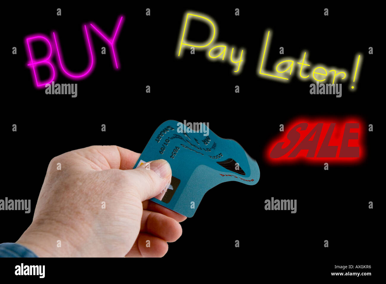 Hand holding credit card showing stress from over use Stock Photo - Alamy