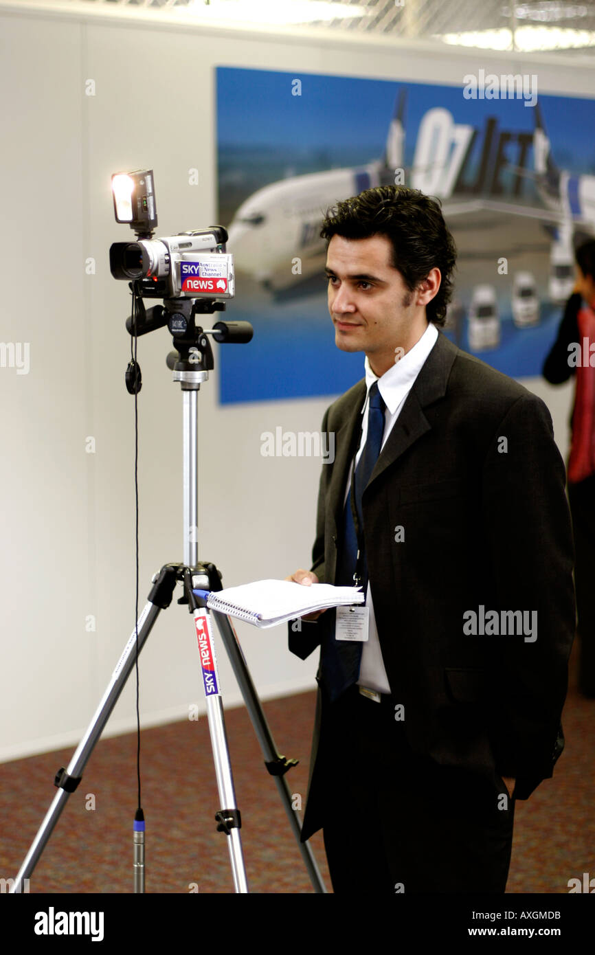 A video journalist conducts a news interview for cable television ...