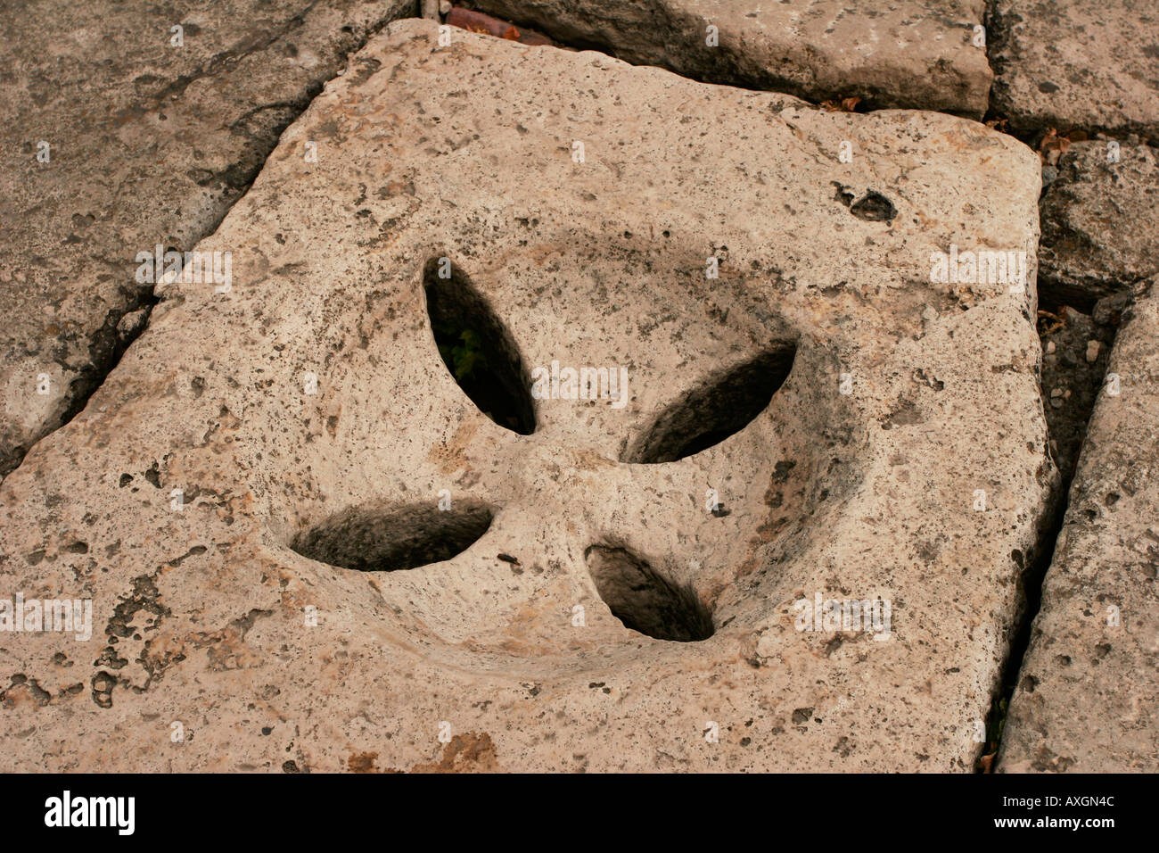 Roman drain cover in the road at the ruined Roman town of Aquincum near ...