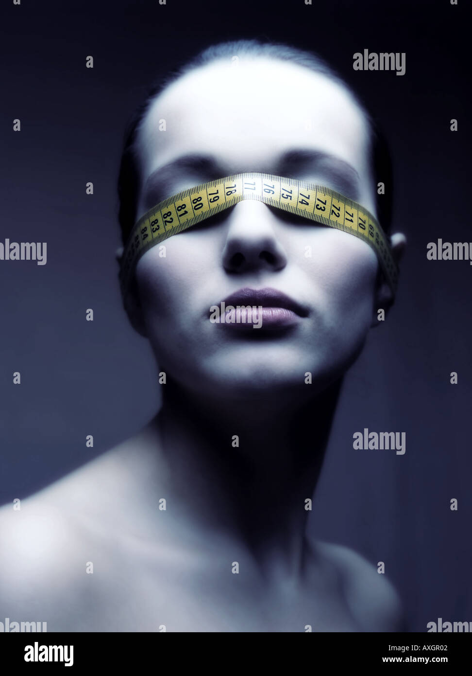 Young woman with a measuring tape wrapped around her eyes Stock Photo ...