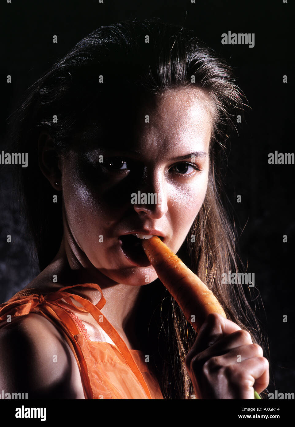 Woman biting carrot hi-res stock photography and images - Alamy