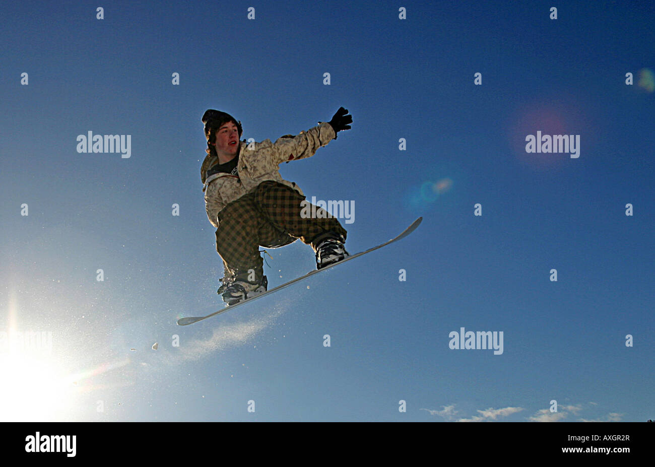 A colour horizontal picture showing a snowboard soaring through the air ...