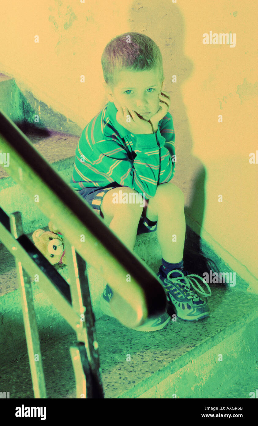 Small boy sitting on a stairs Stock Photo - Alamy