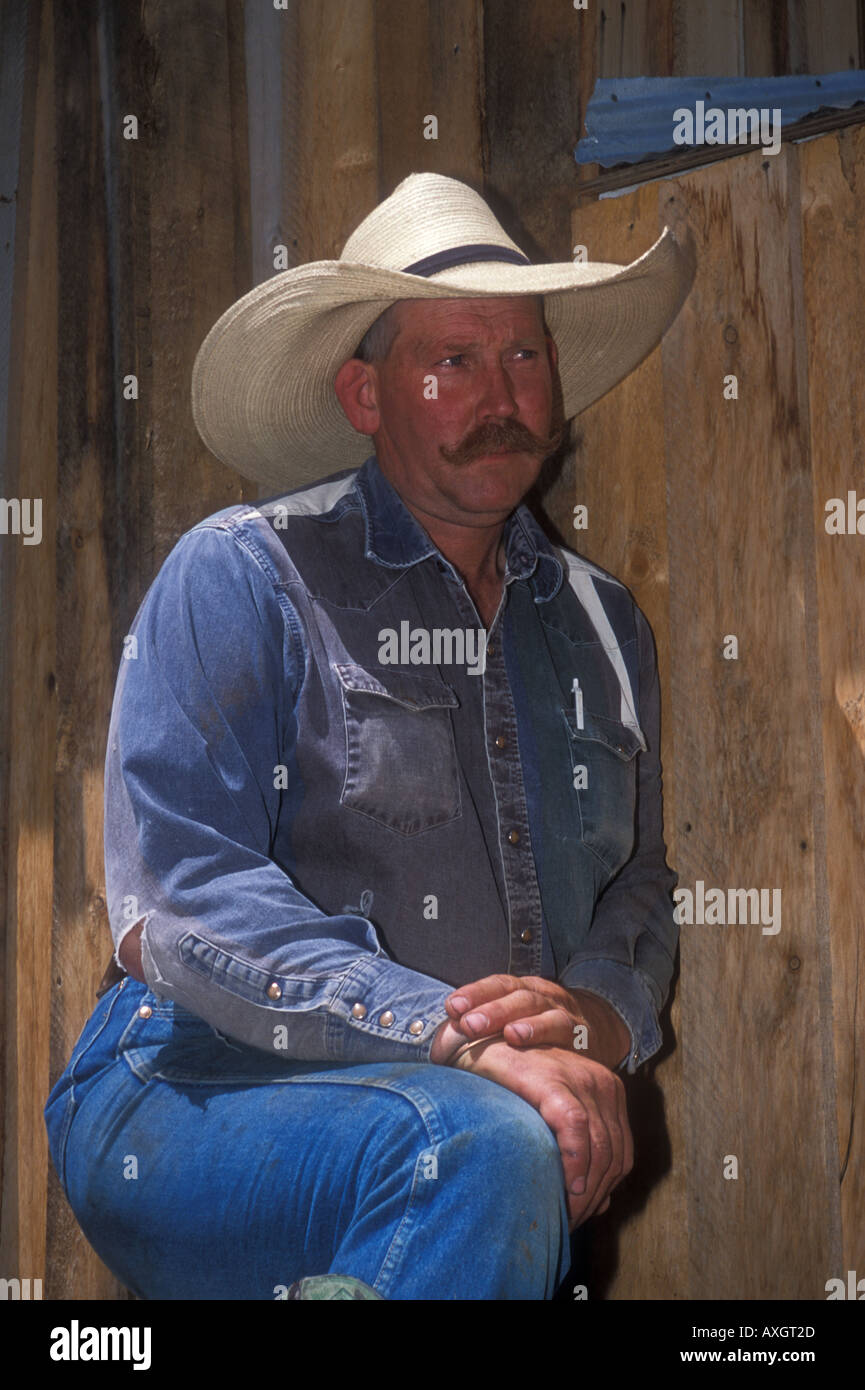 A cowboy stands by a barn Stock Photo - Alamy