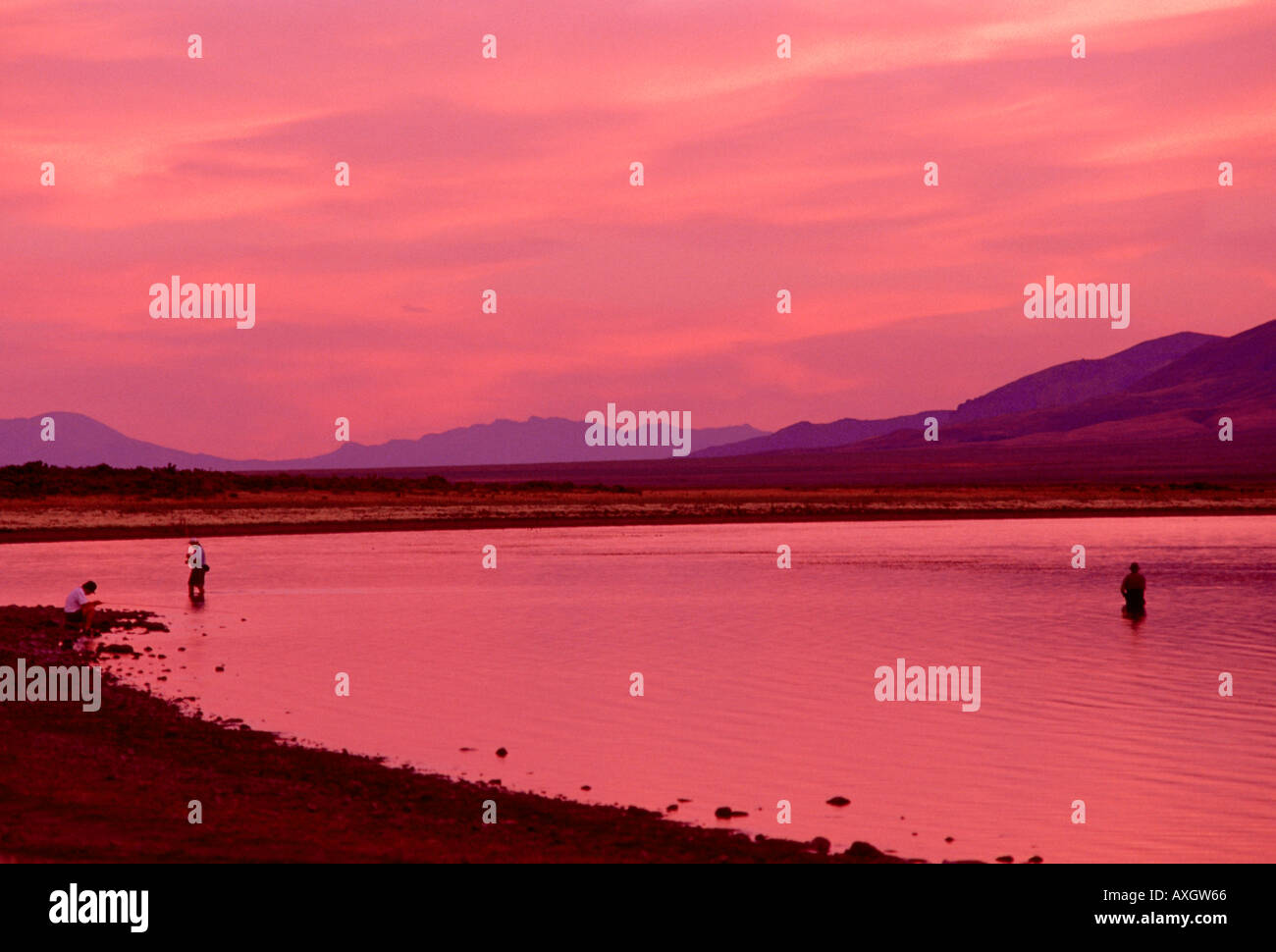 silhouette men flyfishing at sunset wading in Mann Lake Northern Great ...