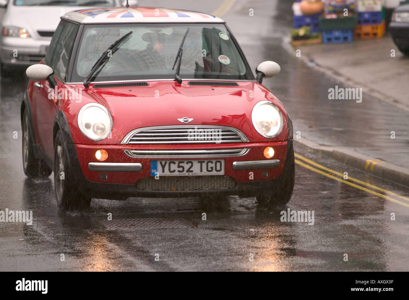 a red mini driving in the rain Stock Photo - Alamy