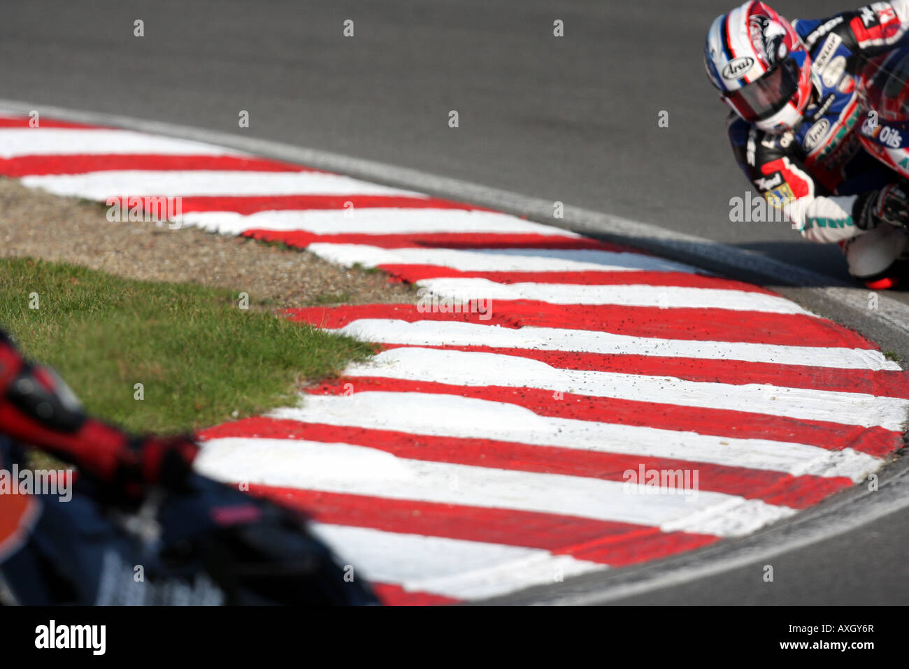race corner with bikes racing round the painted kerb rumbbe strip Stock ...