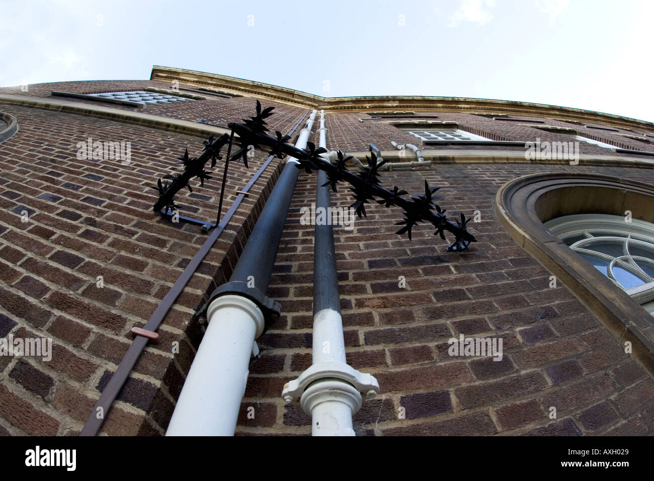 Security device attached to building over piping Stock Photo - Alamy
