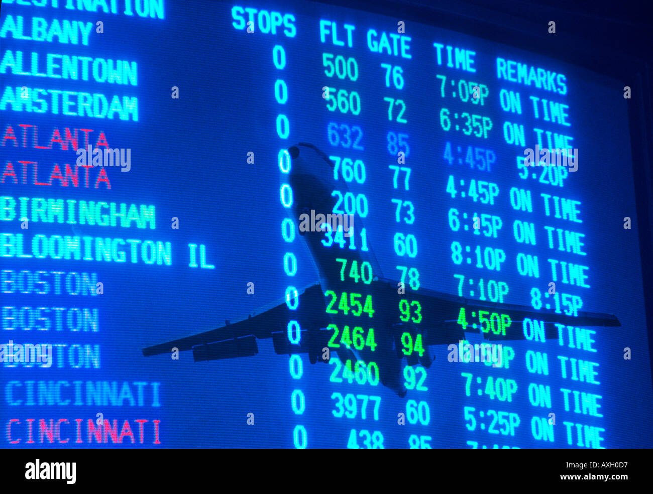 composite image of large jet airplane and airport departure screen ...