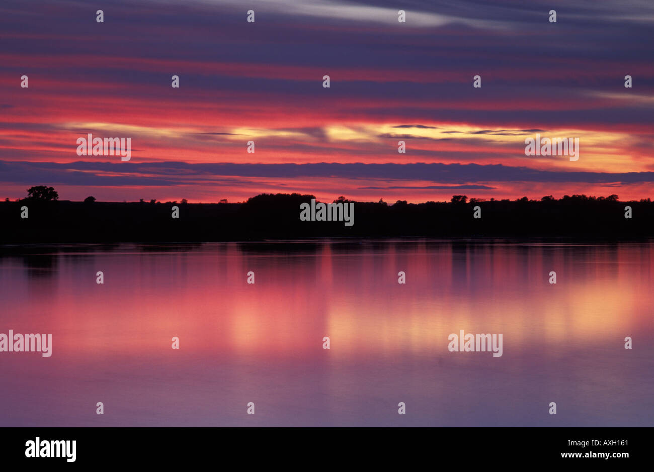 Mirrored Sunset over Water Stock Photo - Alamy