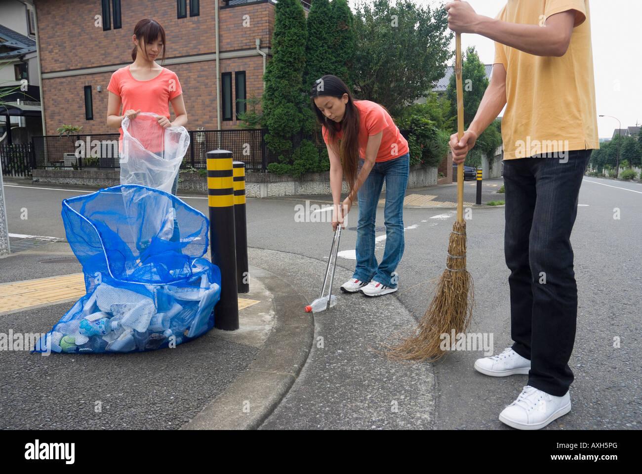 Young people cleaning garbage Stock Photo - Alamy