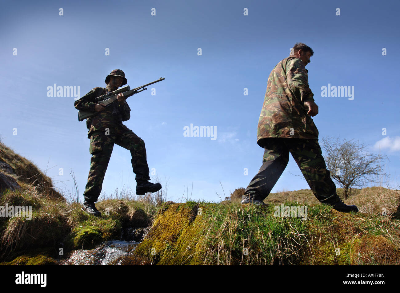 A BRITISH ARMY FEMALE FOLLOWING A COLOUR SERGEANT INSTRUCTOR ON A ...