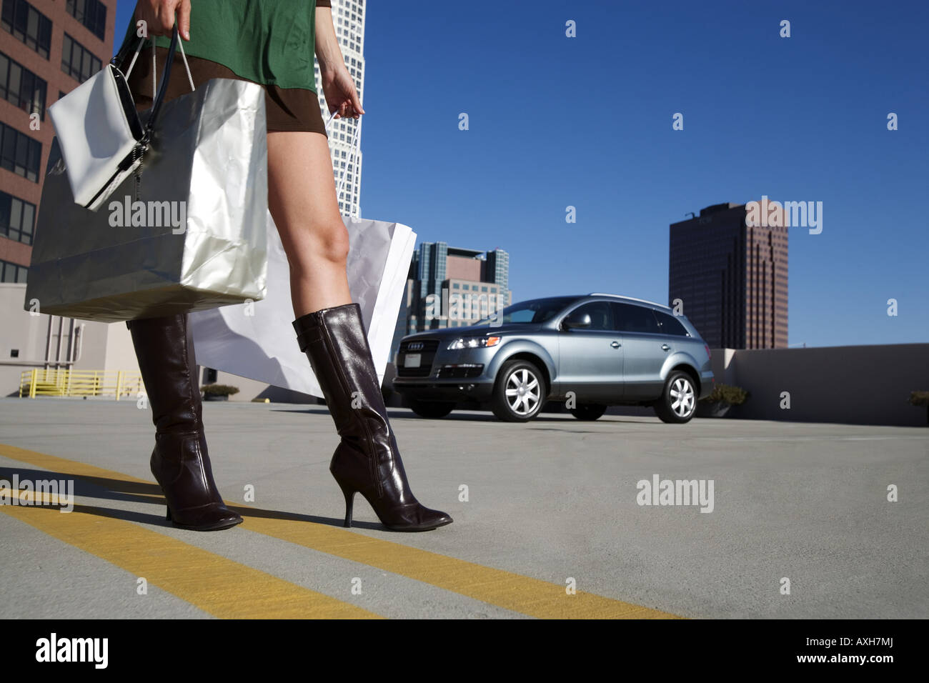 Woman in car park returning to car Stock Photo - Alamy