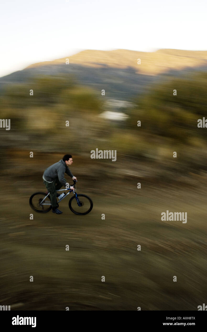 Man riding mountain bike on trail Stock Photo - Alamy