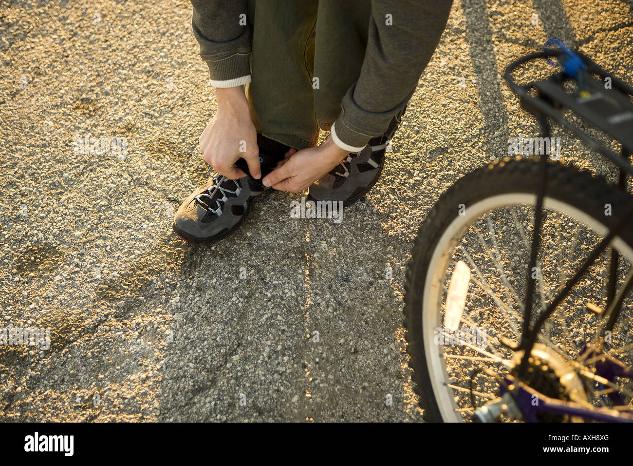 Overhead view of man adjusting shoes Stock Photo - Alamy