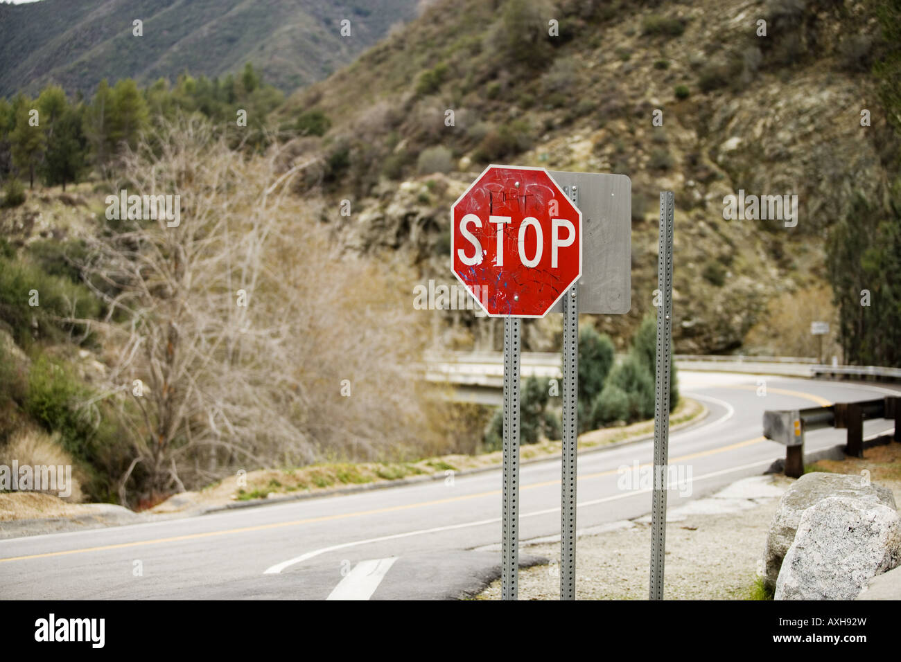 Stop sign on mountain road Stock Photo - Alamy