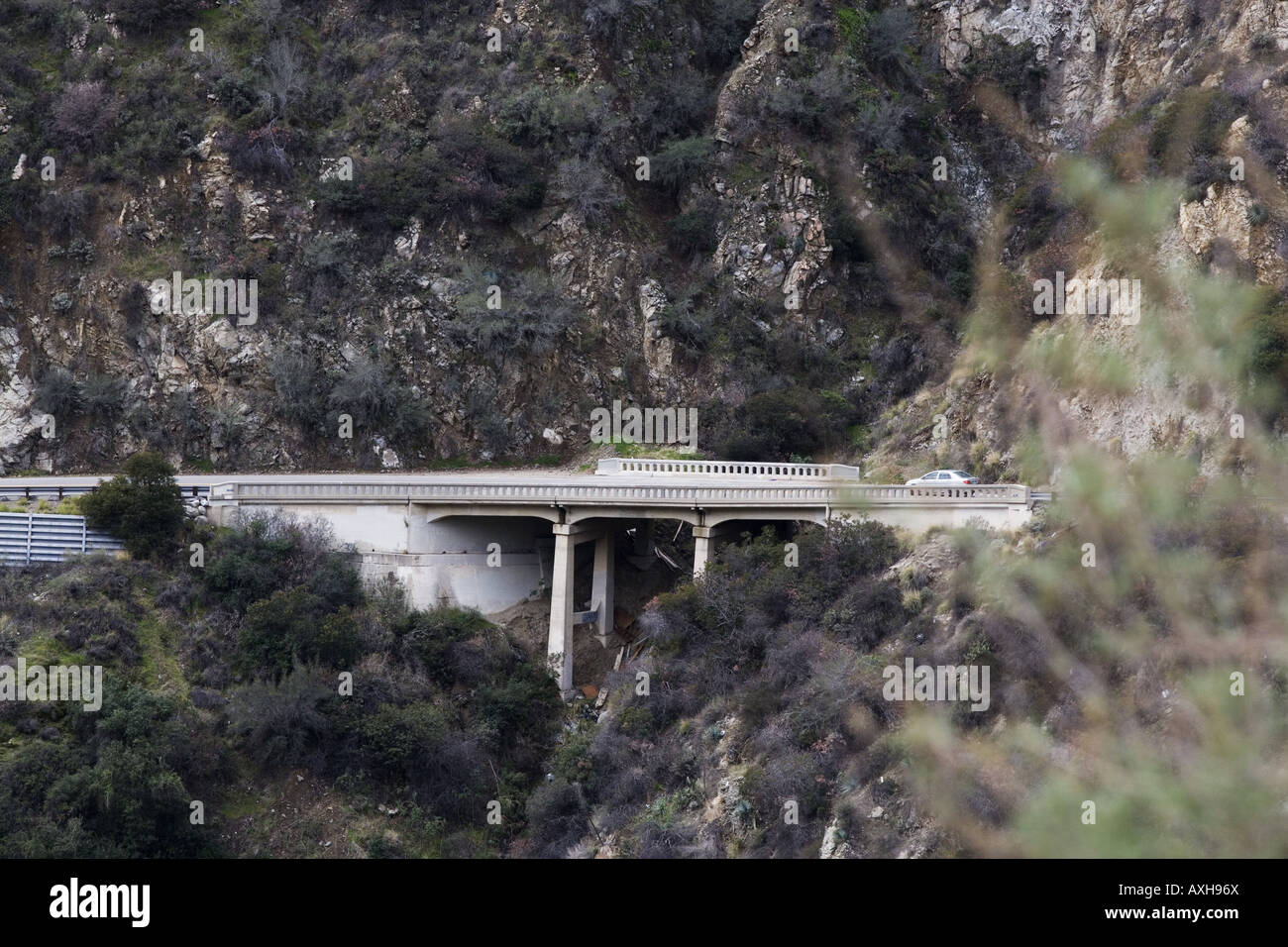 Bridge over mountain road Stock Photo - Alamy