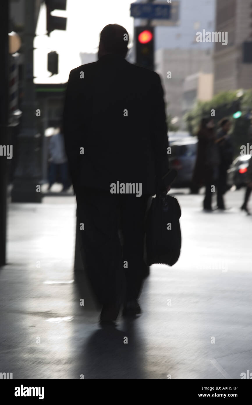 Man walking on sidewalk Stock Photo - Alamy