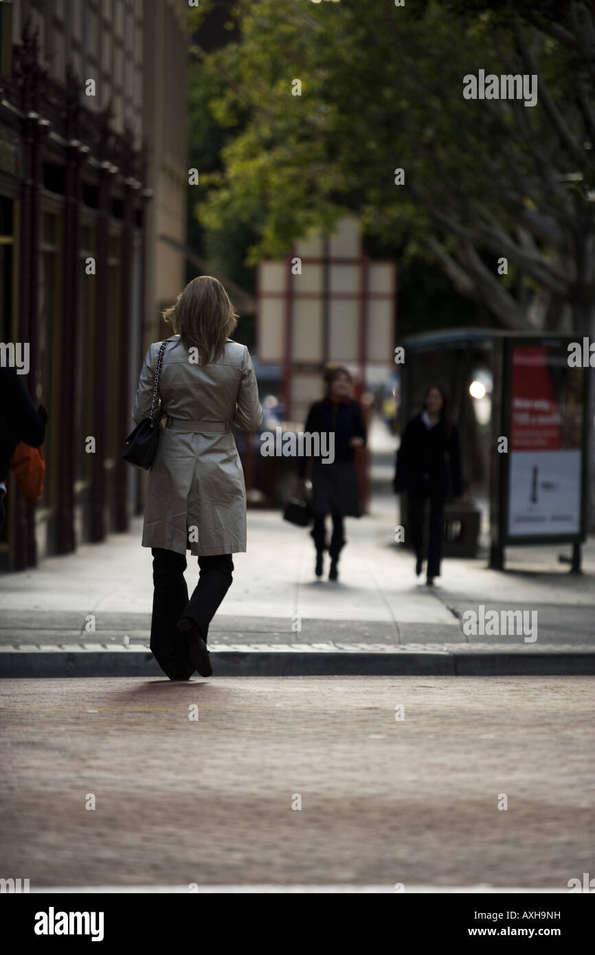 Woman crossing street Stock Photo - Alamy