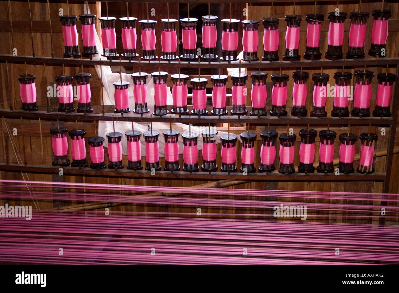 Stock photograph of spools of silk spinning as the thread is drawn off ...