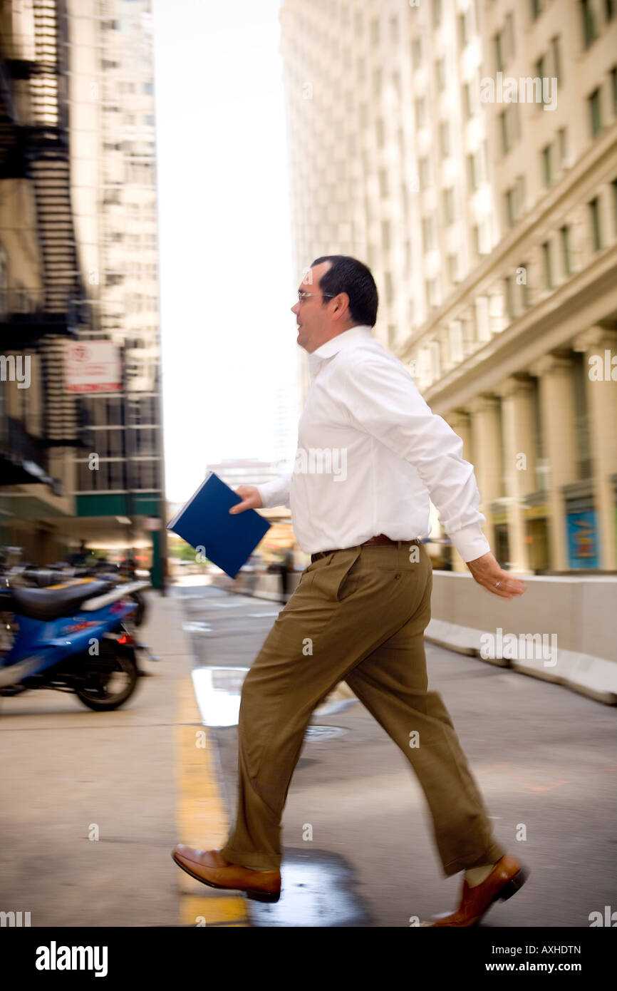a business man jumps over a street mark Stock Photo - Alamy