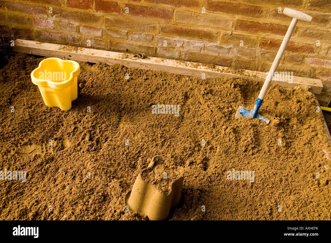child's sand box with bucket spade and sandcastle Stock Photo - Alamy