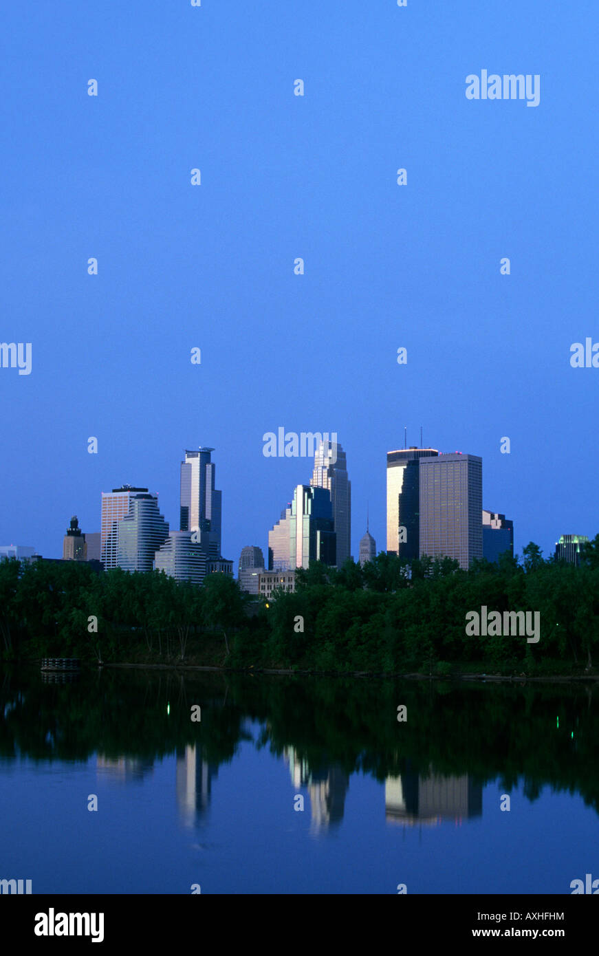 REFLECTION OF MINNEAPOLIS, MINNESOTA SKYLINE IN LORING PARK LAKE. EARLY ...