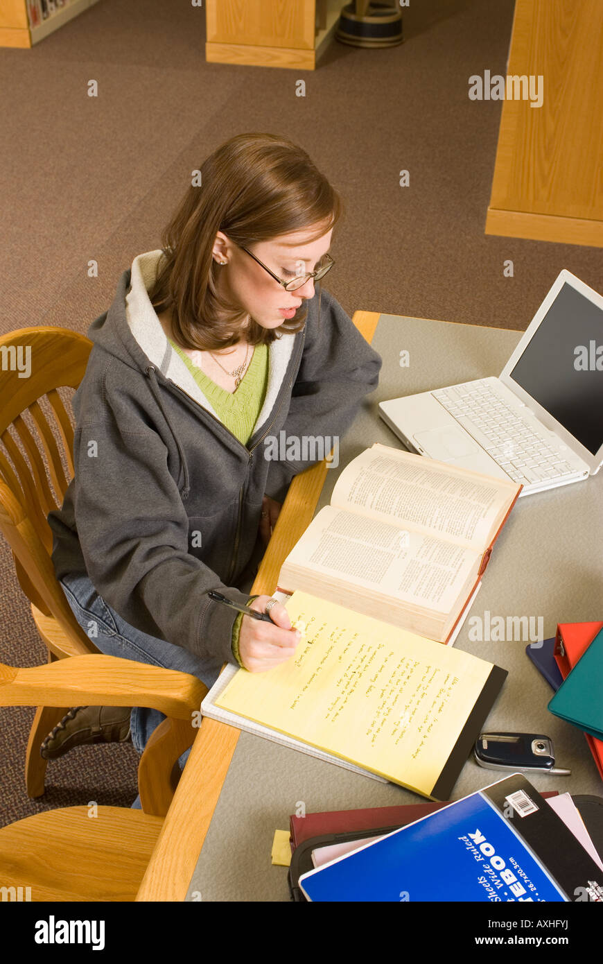 a young woman studies in the library Stock Photo - Alamy