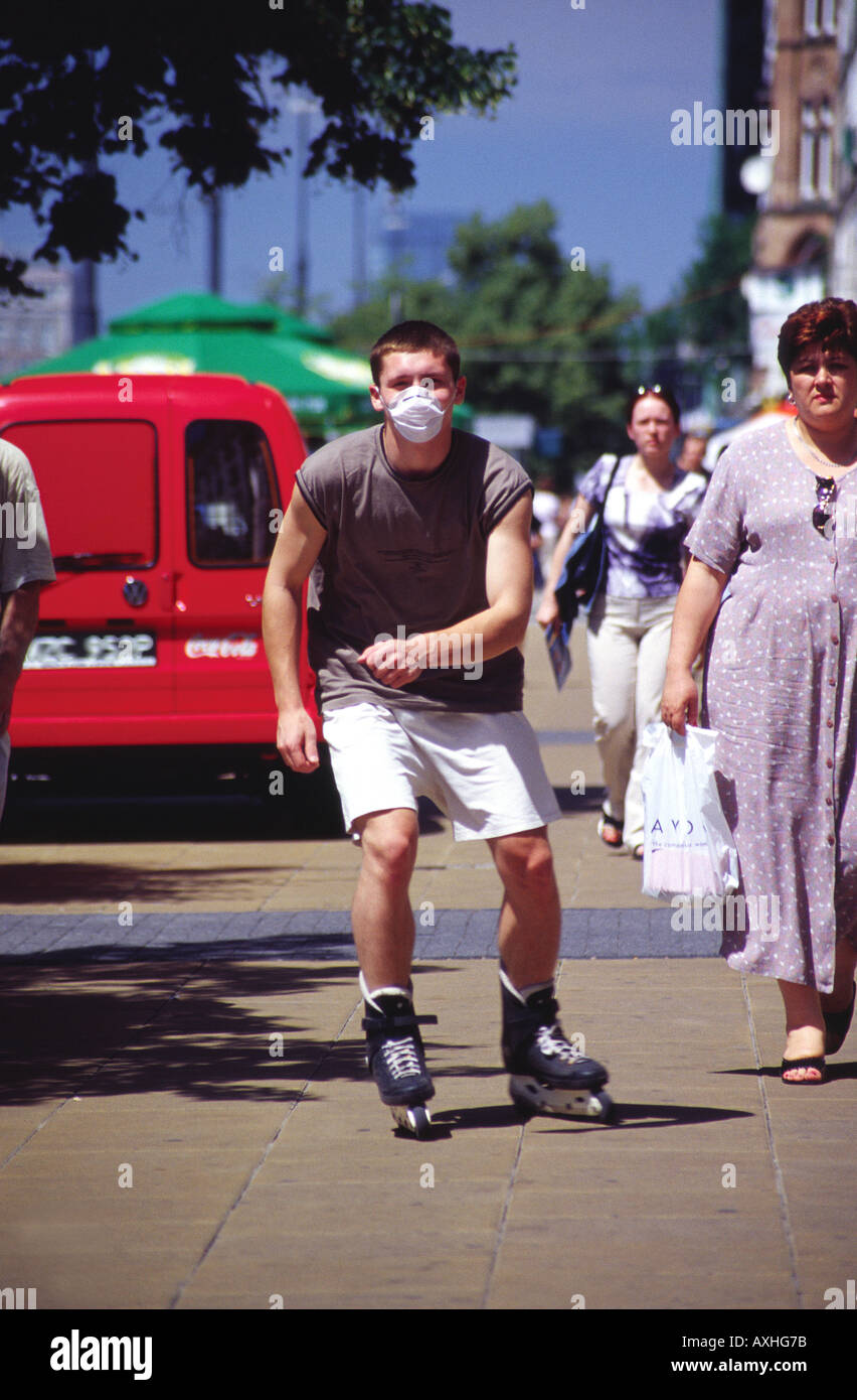 Young man roller skating at the busy street Stock Photo - Alamy